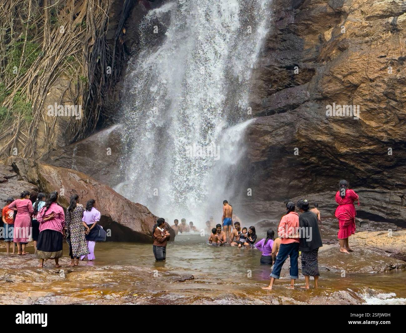 Indian tourists swim at Soochippara Falls also known as Sentinel Rock ...
