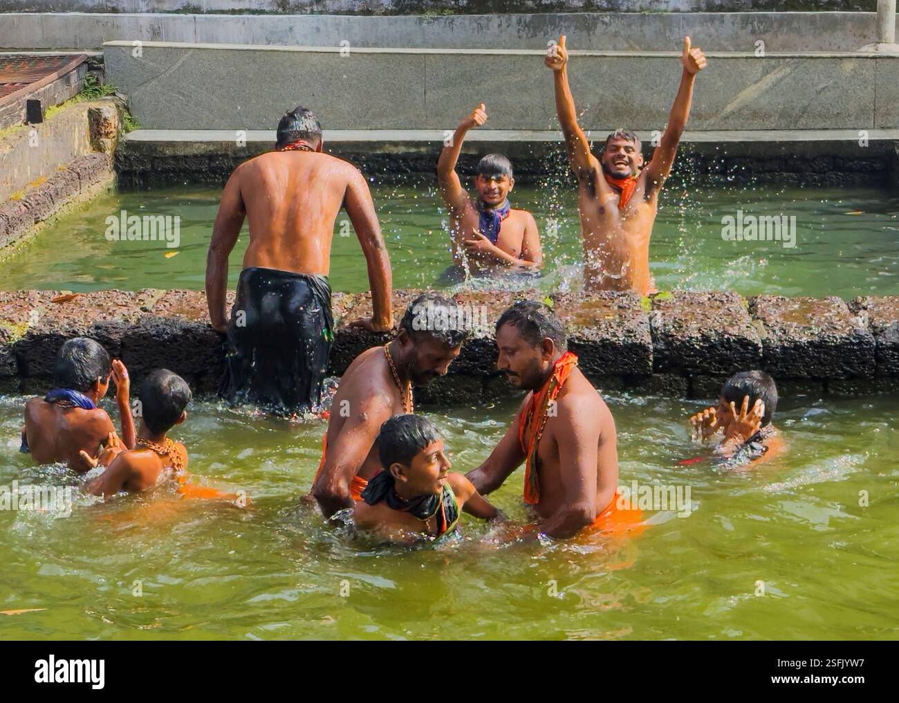 Men and boys swim in sacred pools at Kandri Manjunath Temple which is a ...