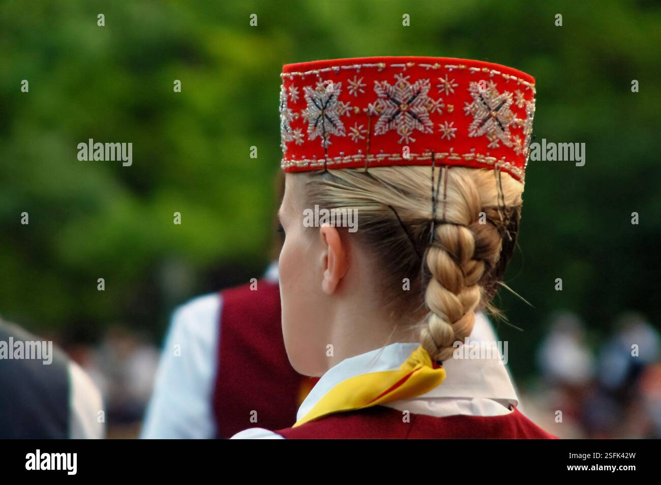 A young woman in a traditional Latvian folk attire. She wears a ...