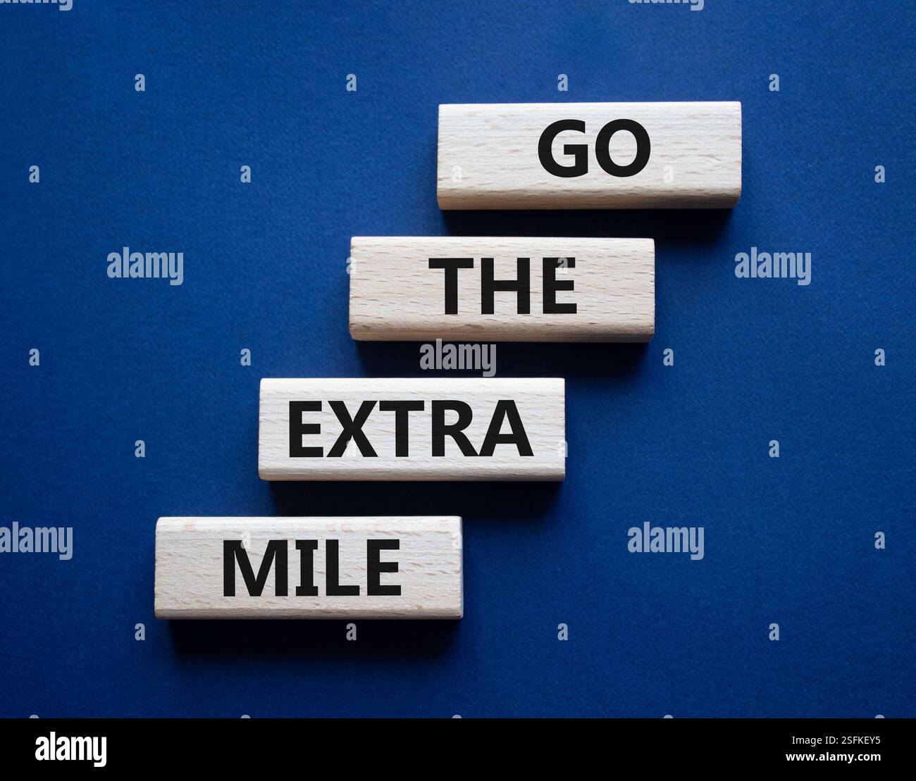 Go the extra mile symbol. Wooden blocks with words Go the extra mile ...