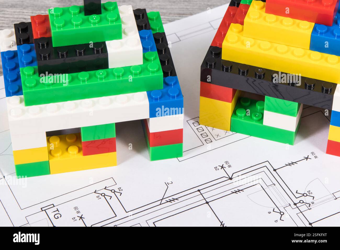 Small houses made of colorful toy blocks and electrical diagrams of ...