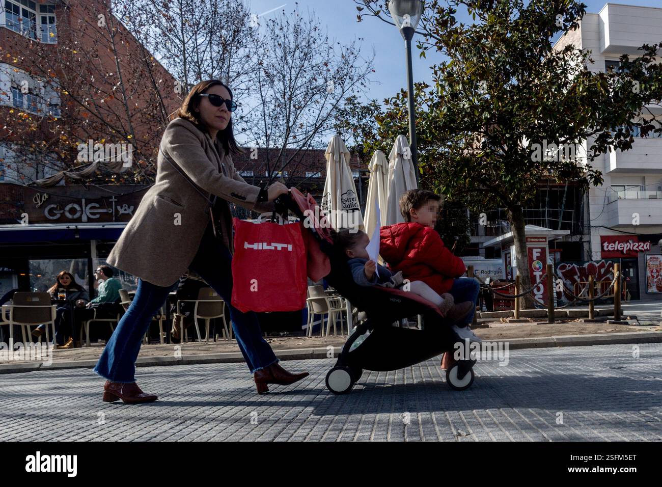 A woman carries a baby carriage on February 9, 2025, in Madrid (Spain ...
