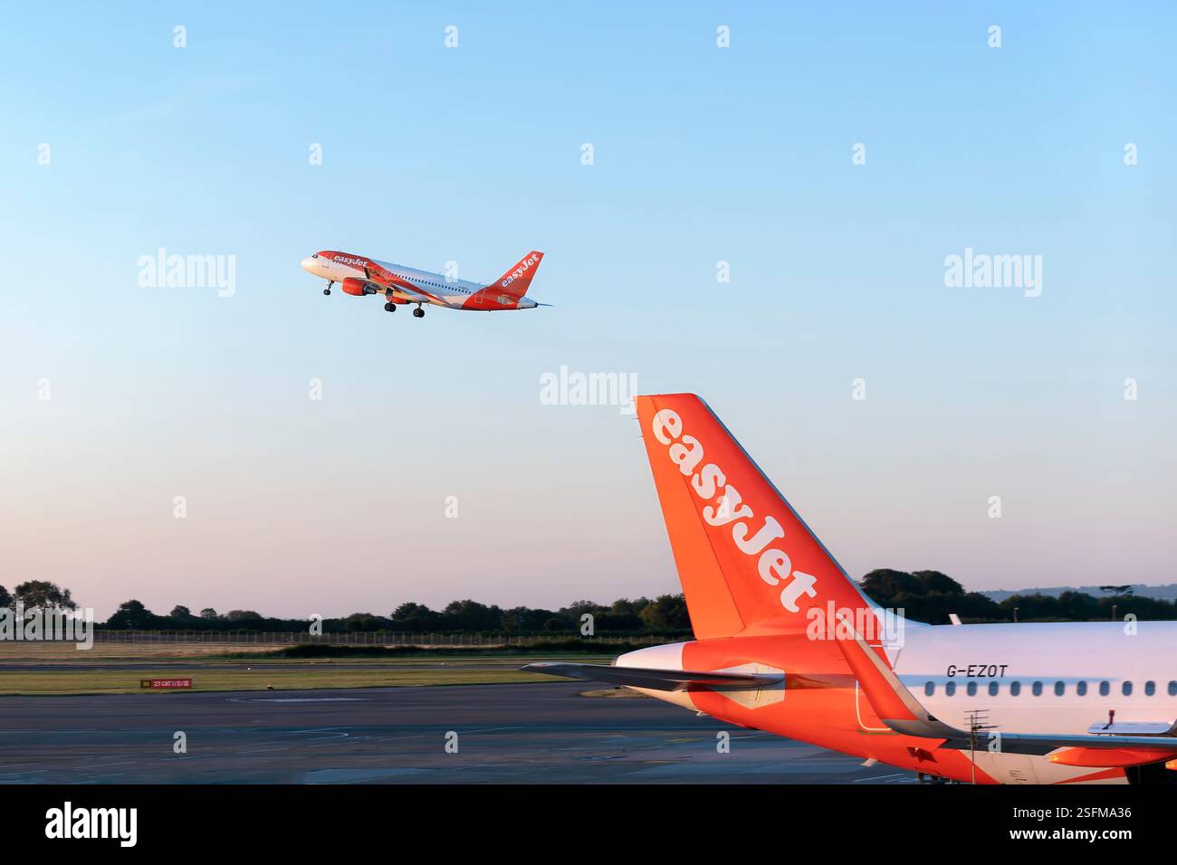 Bristol airport UK. An easyjet plane taking off early in the morning ...