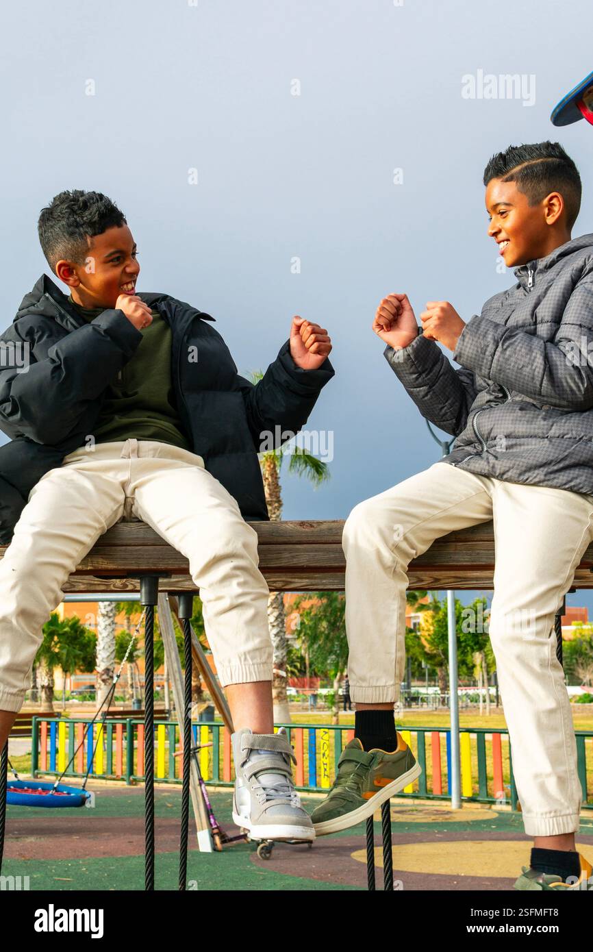 Two young brothers are enjoying their time together, playing and ...