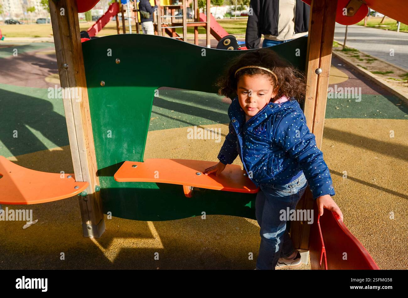 Young child enjoying outdoor playtime on a bright, colorful play ...