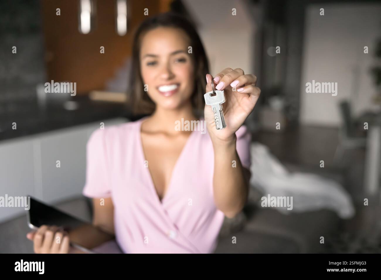 Realtor holds key toward camera and welcoming new homeowner Stock Photo ...