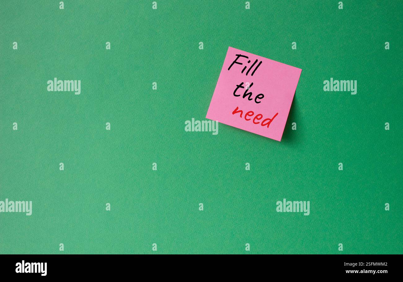 Fill the need symbol. Concept word Fill the need on steaky pink note ...