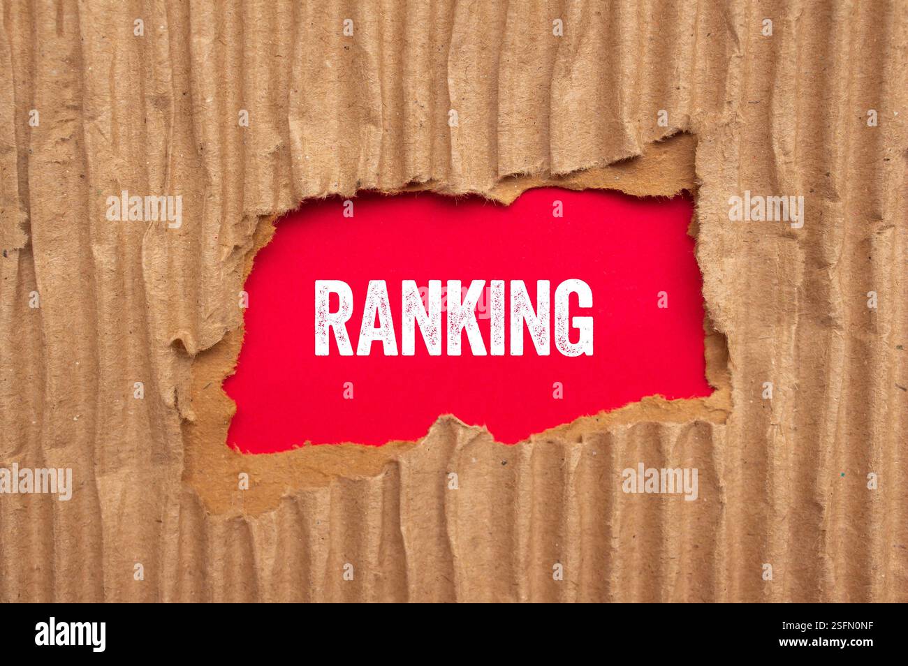Ranking message written on ripped torn cardboard paper on red ...