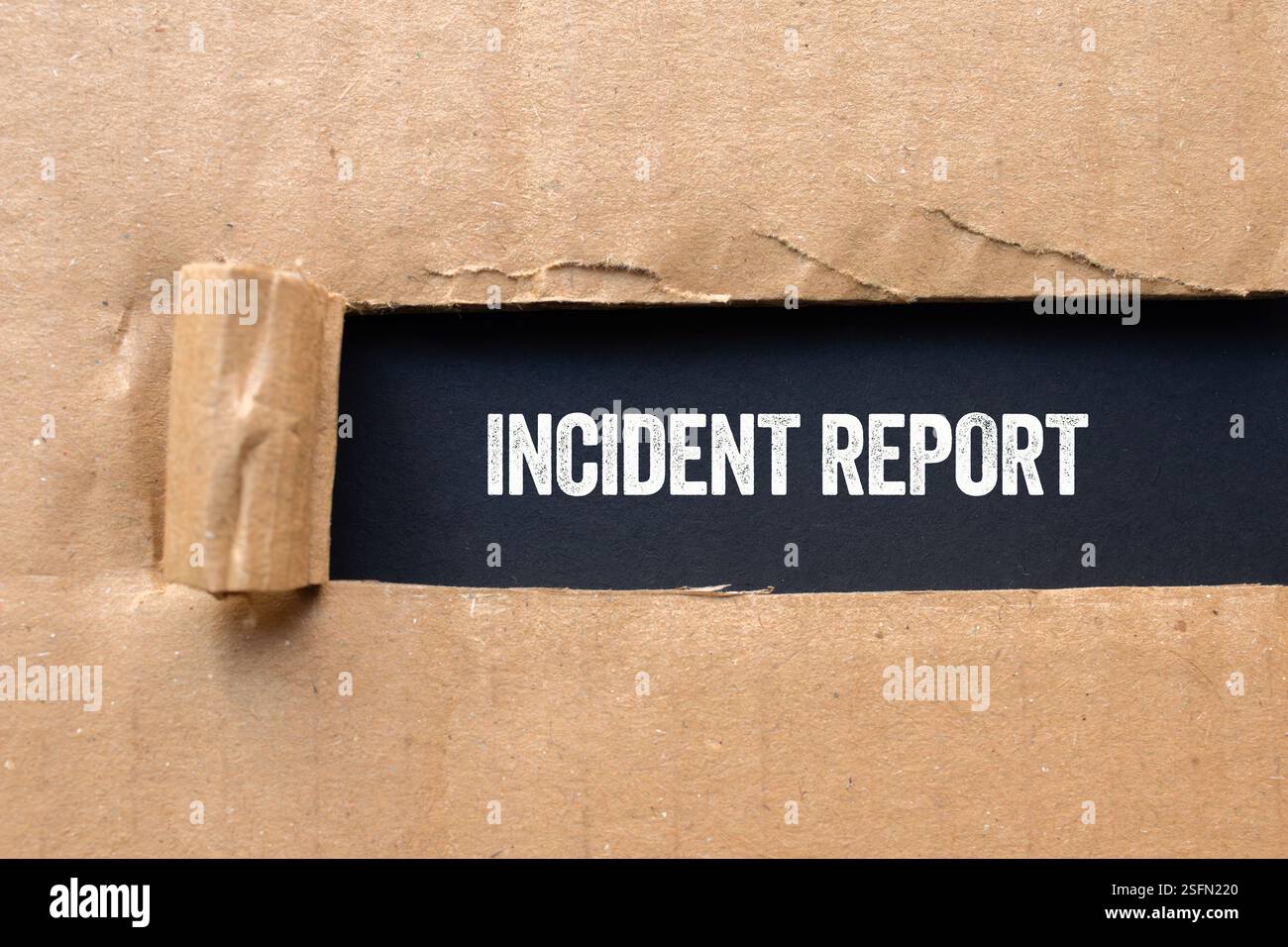 Incident report message written on ripped torn cardboard paper on black background. Conceptual ...