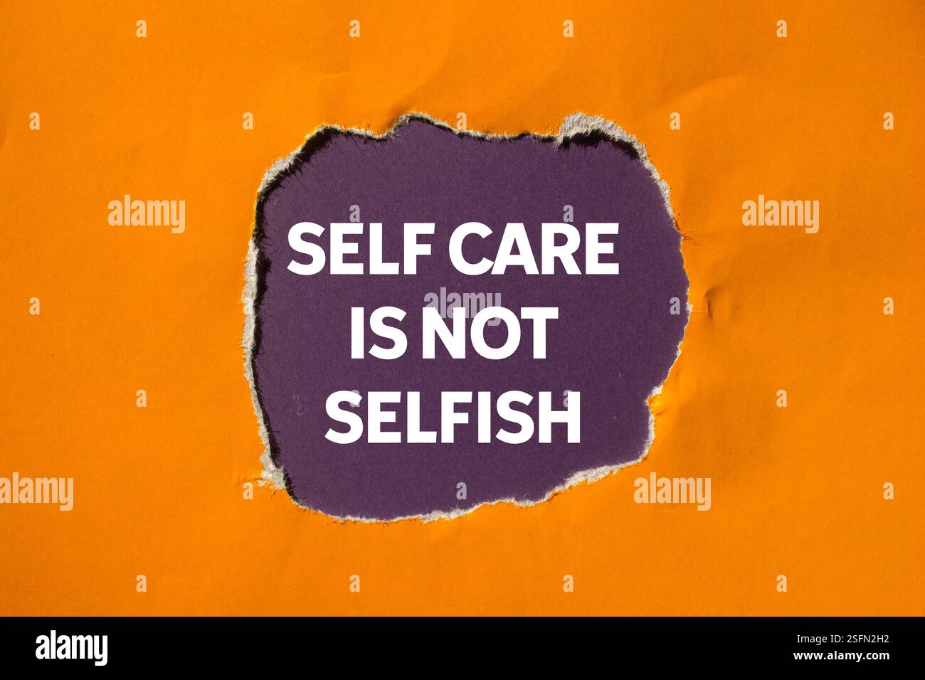Self care is not selfish message written on ripped torn orange paper on purple background ...