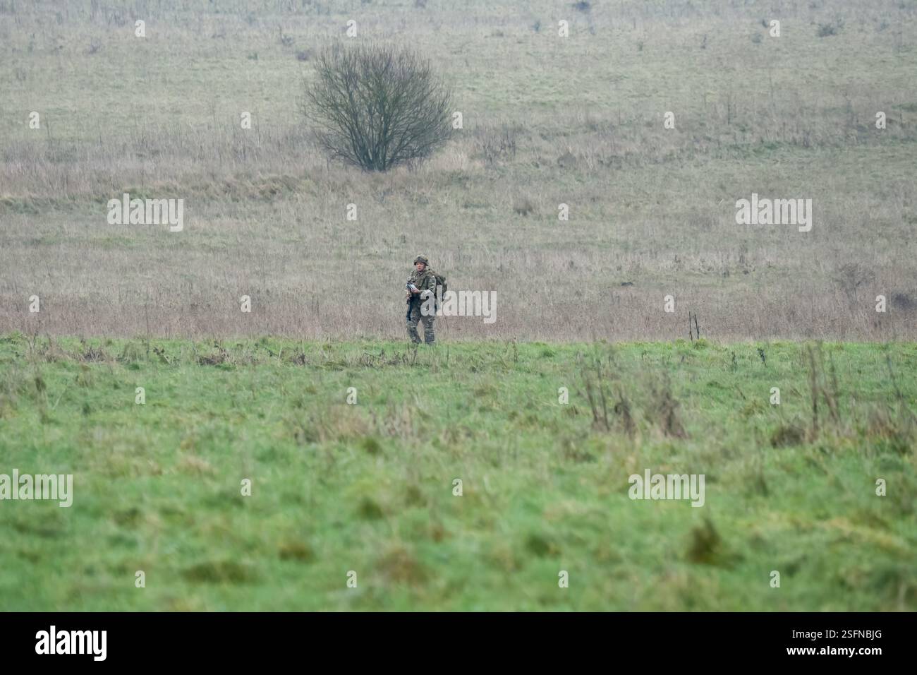a British army infantry soldier on a tabbing exercise bearing full 40Kg ...