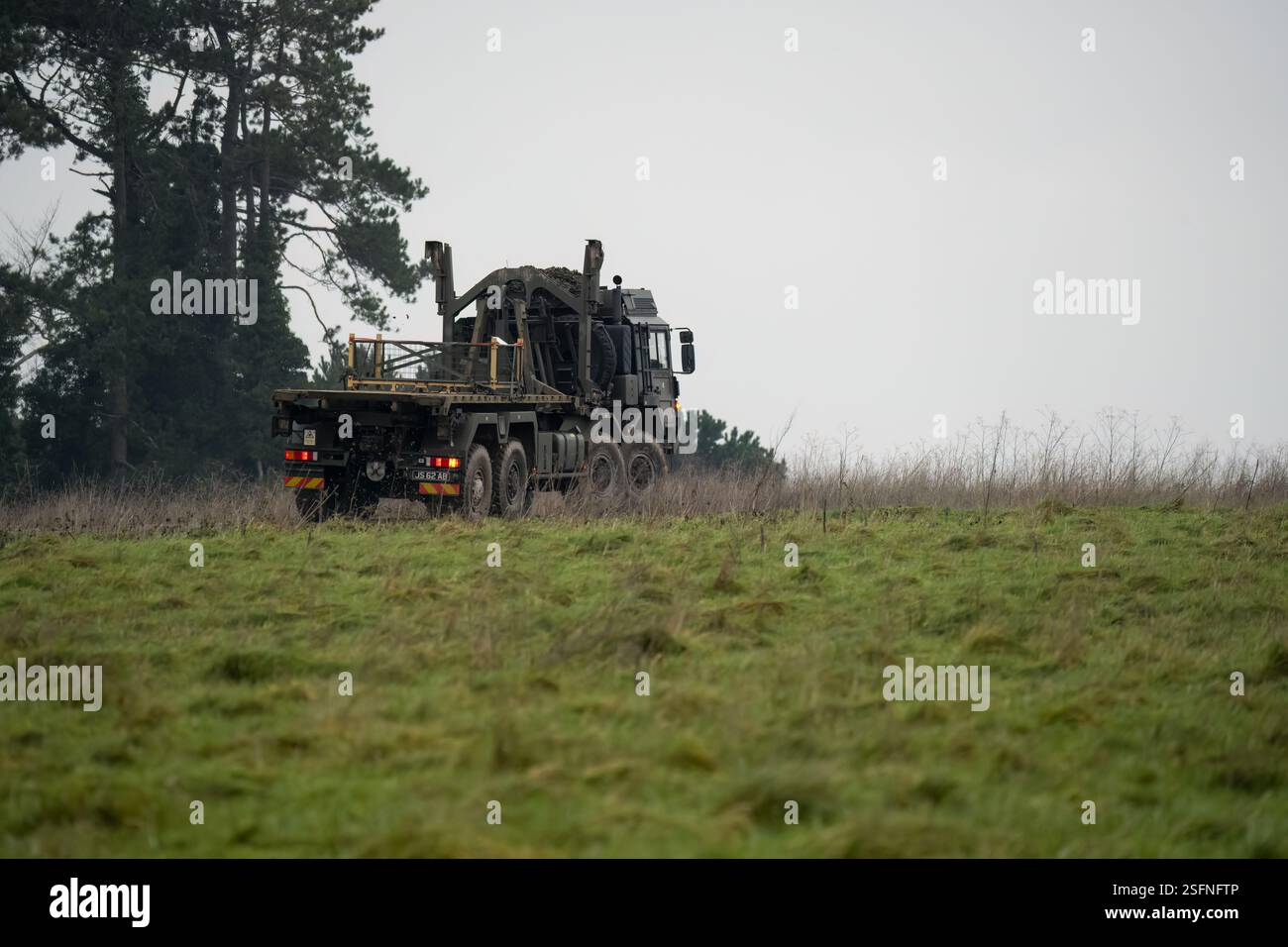 British army MAN SV 8x8 EPLS logistics truck driving an unmade road, in ...