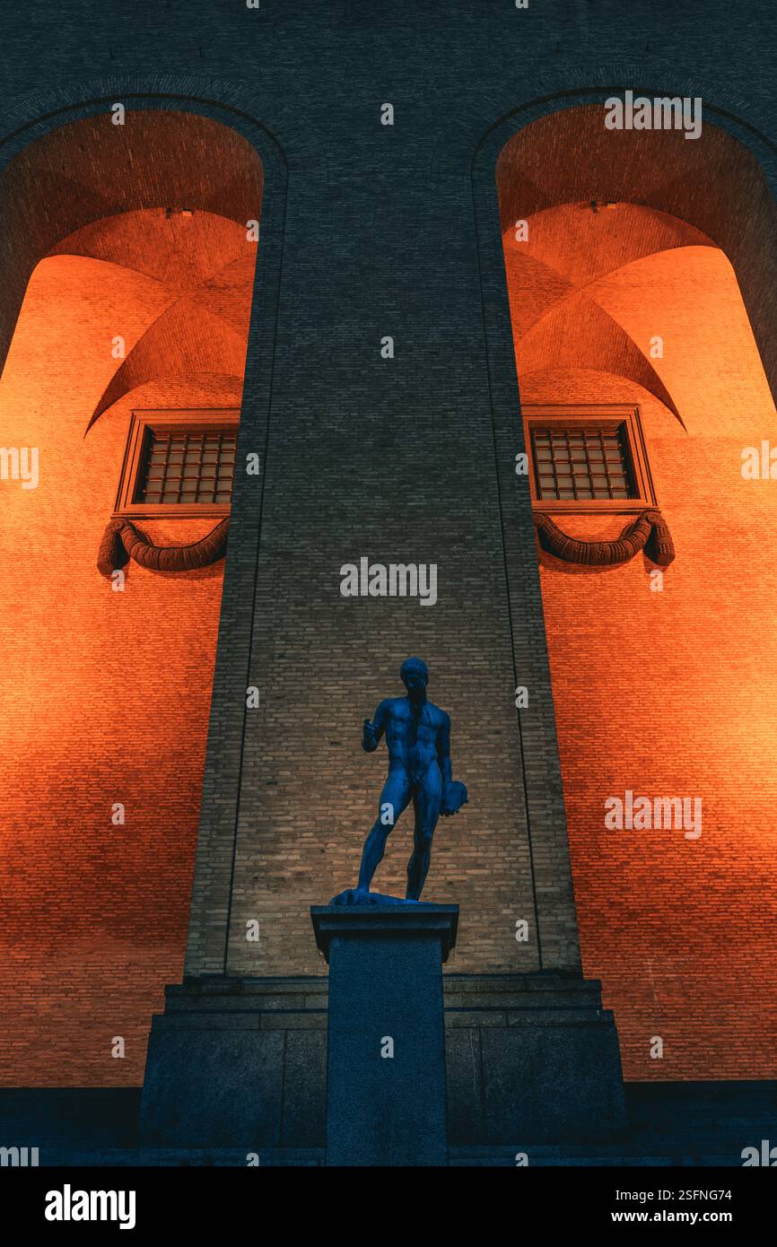 A striking statue stands proudly in front of a majestic building in ...