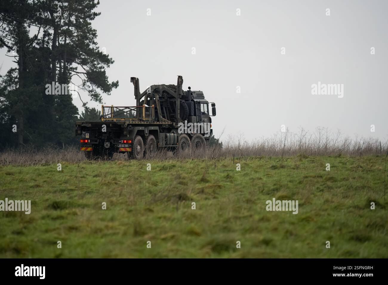 British army MAN SV 8x8 EPLS logistics truck driving an unmade road, in ...