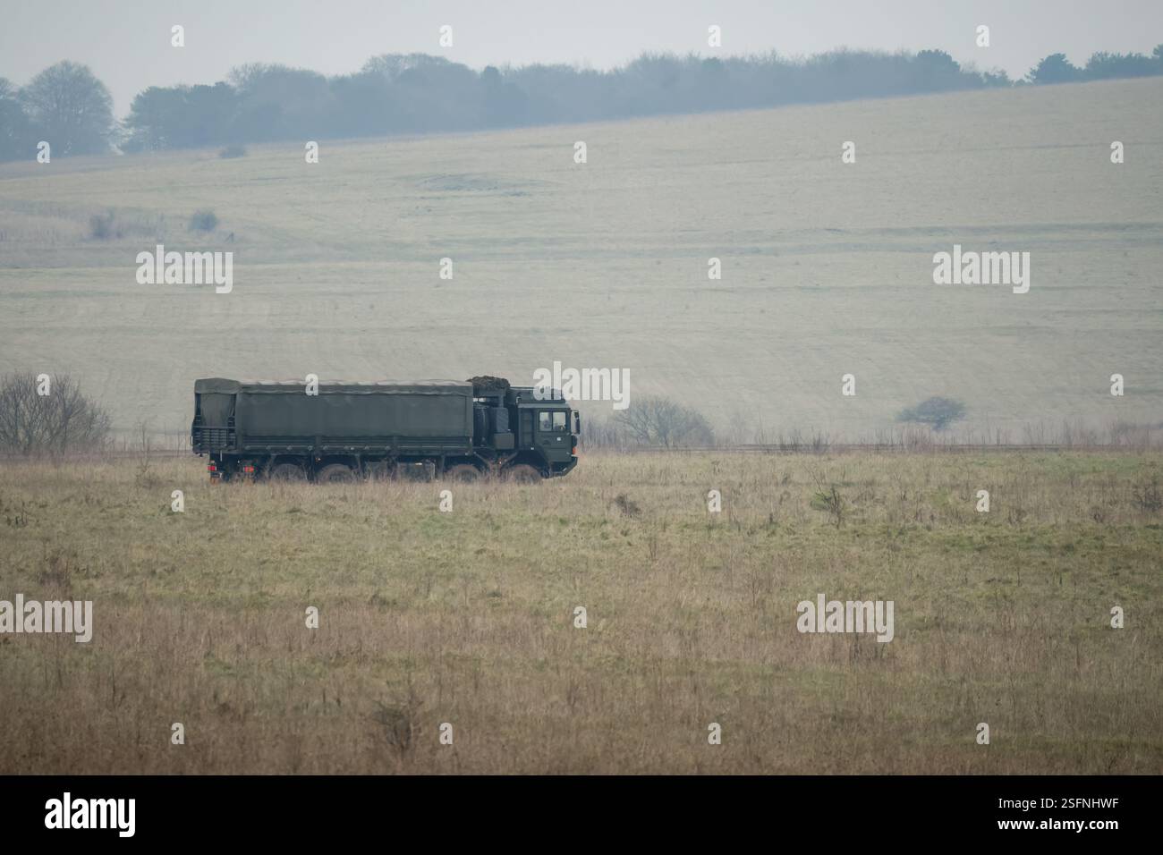 British army MAN SV 8x8 EPLS logistics truck driving an unmade road, in ...