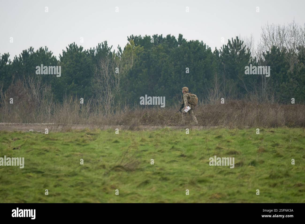 a British army infantry soldier on a tabbing exercise bearing full 40Kg ...