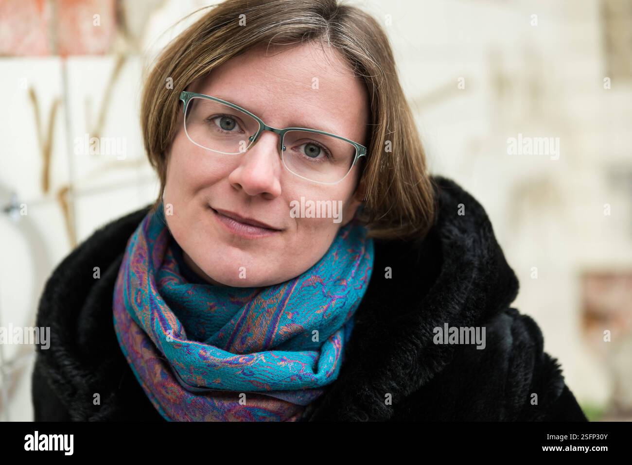 Outdoor portrait of a 33 yo white woman on a grungy inner court ...