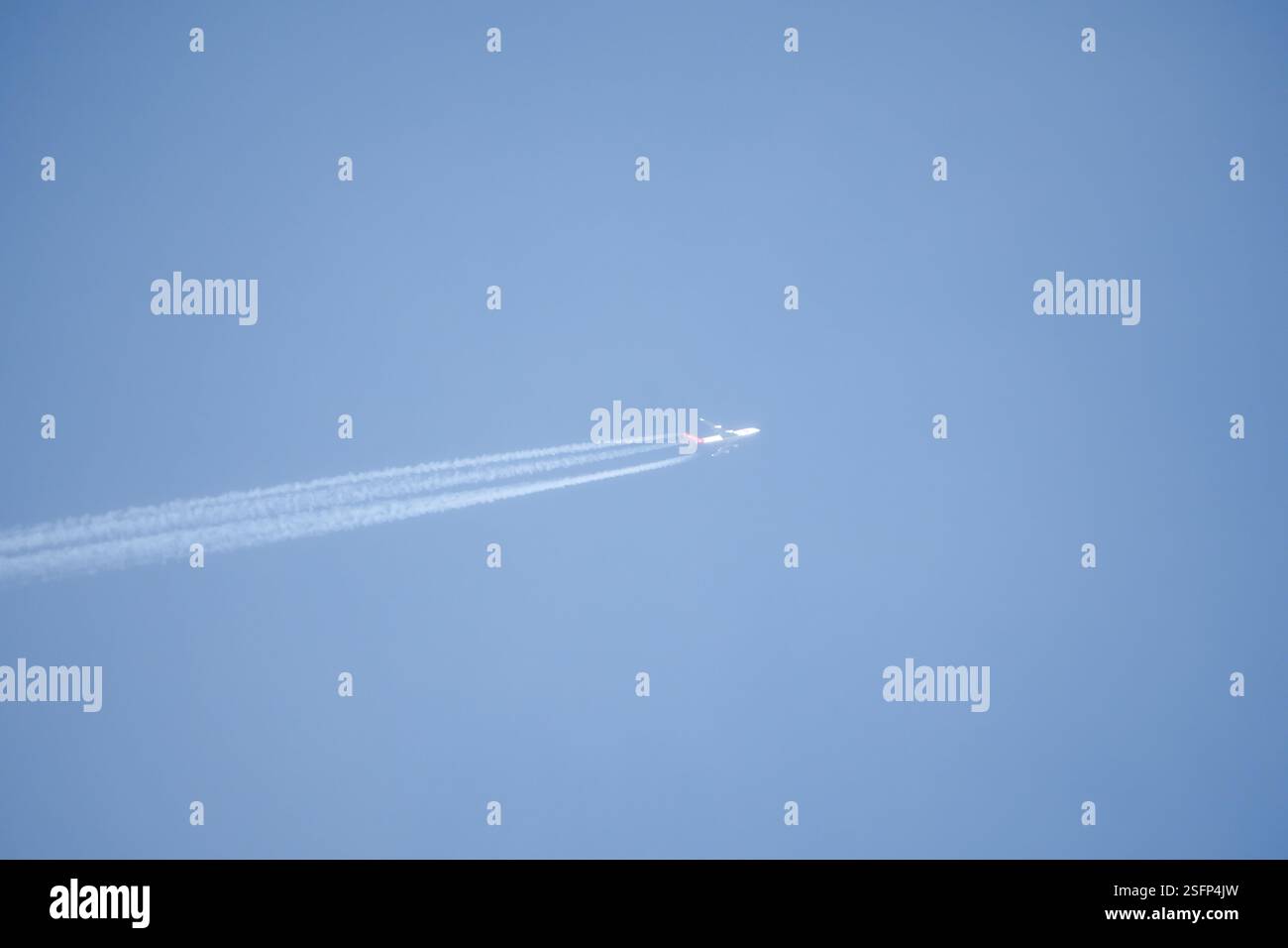 high altitude quad engine contrails (jet airplane vapour trails) across ...