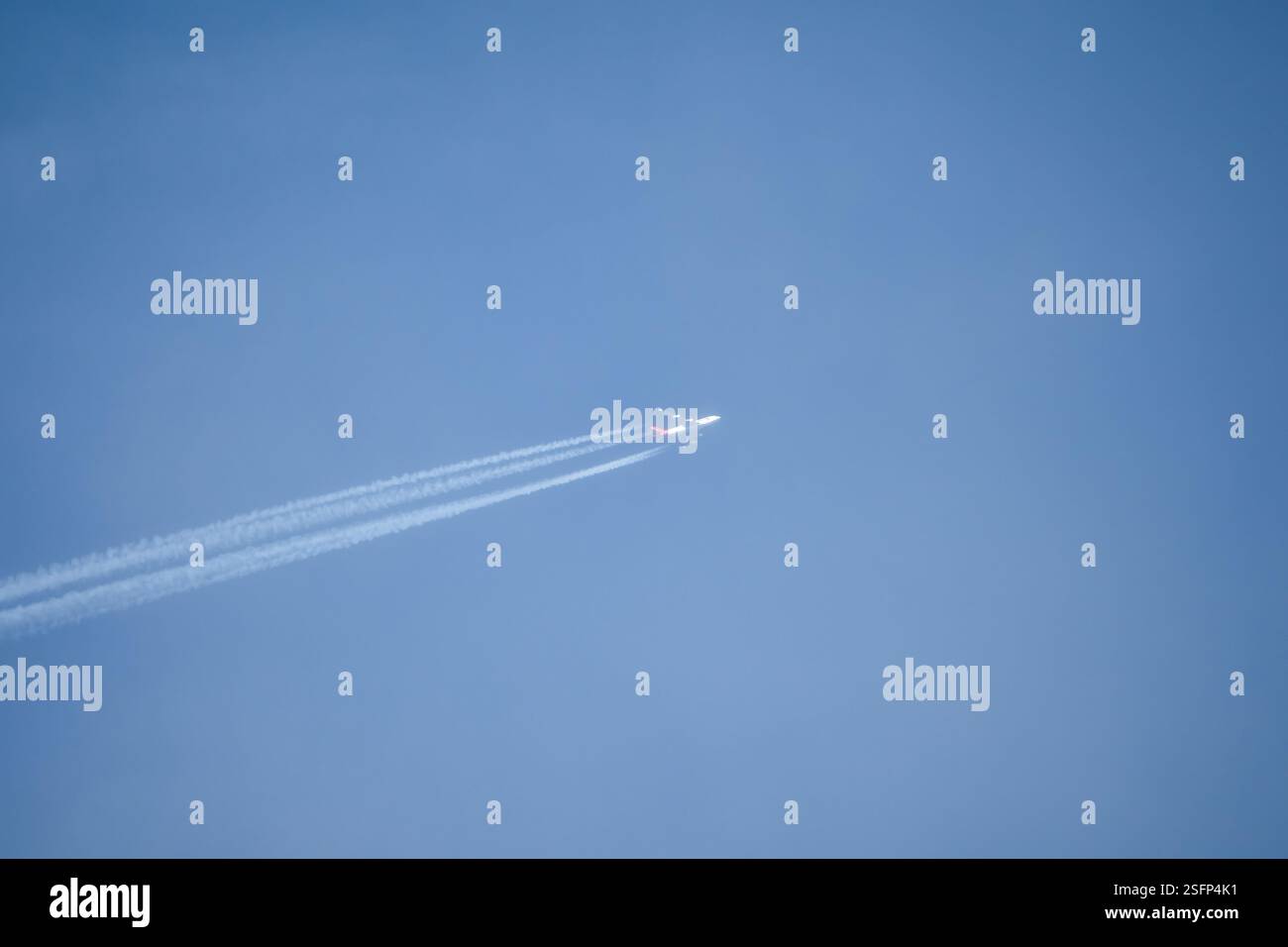 high altitude quad engine contrails (jet airplane vapour trails) across ...