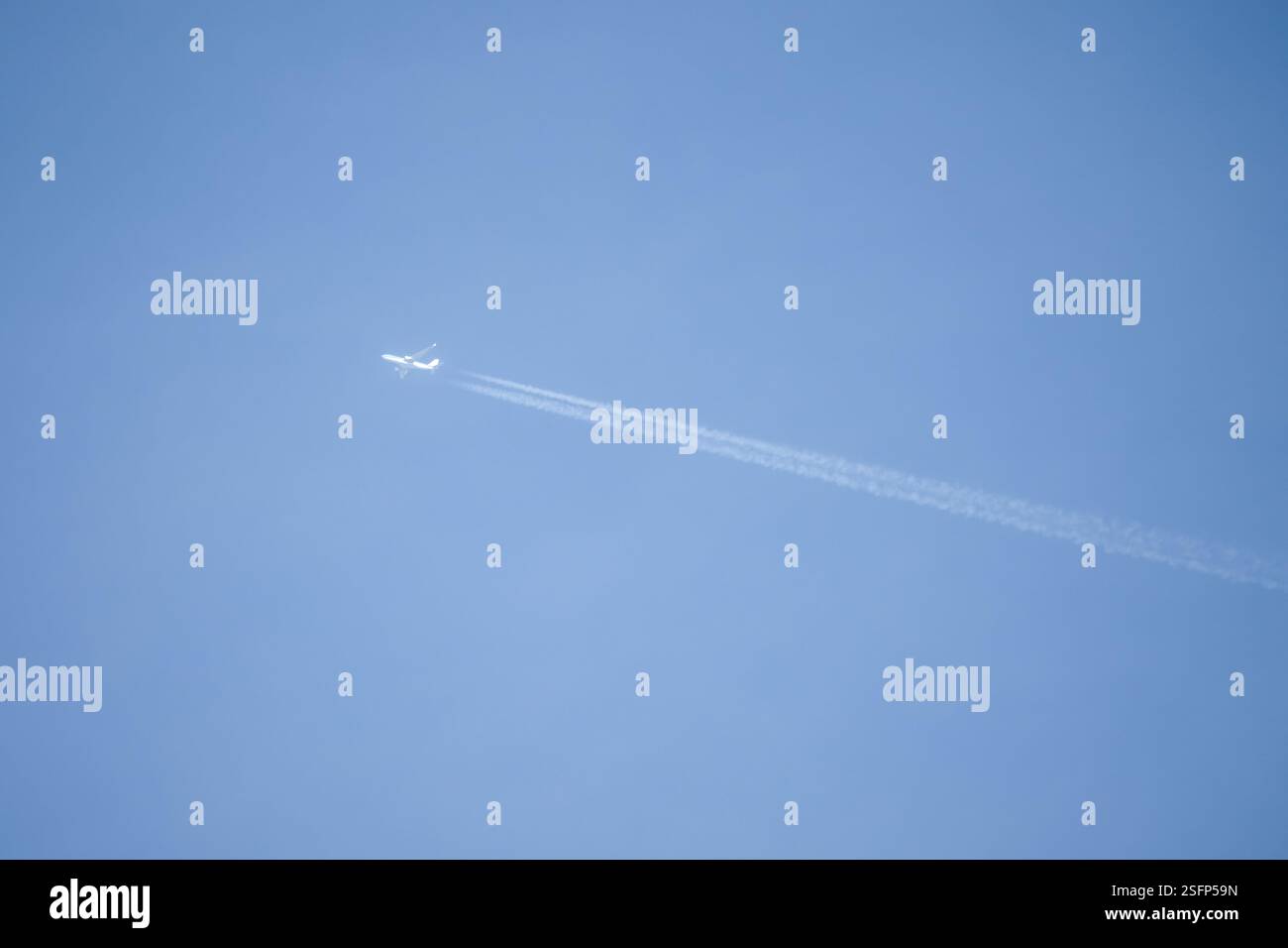 high altitude twin engine contrails (jet airplane vapour trails) across ...