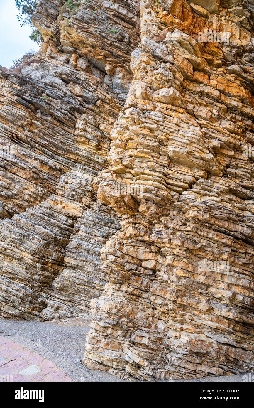 Layered rock texture in Budva, Montenegro. Sedimentary rocks with ...