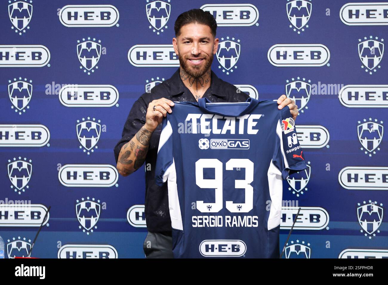 Spanish soccer player Sergio Ramos holds up his jersey during a press ...