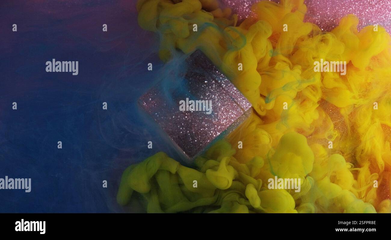 Blending colors. Paint spill. Bright blue yellow pink flow smoke ...