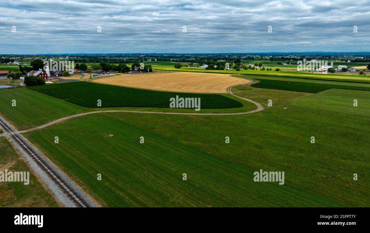 Aerial view captures extensive farmland with lush green fields and ...