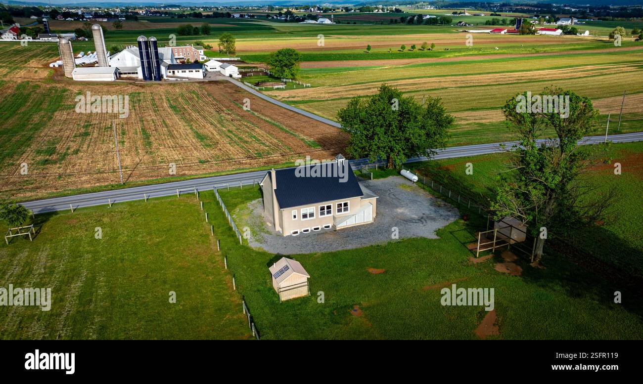 An Amish one room school house sits on a gravel area, surrounded by ...