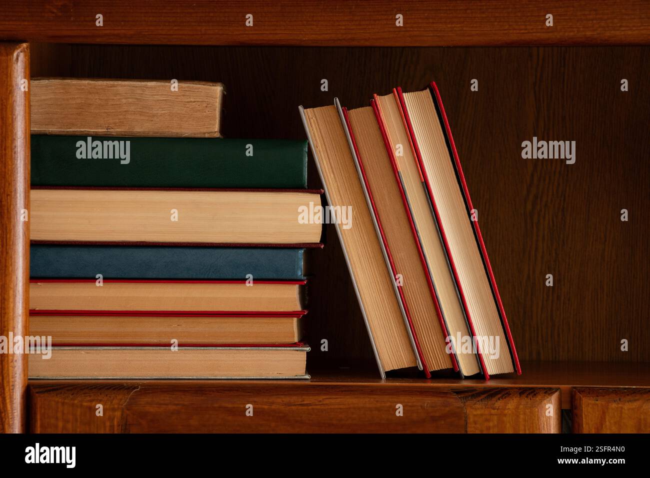 Collection of old books on a wooden shelf in a cabinet, books ...