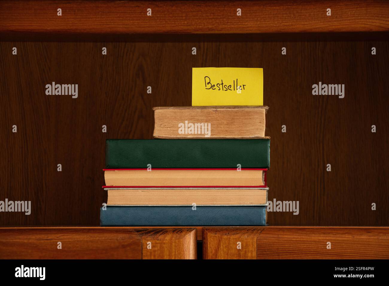 Collection of old books on wooden shelf in cabinet and paper card with ...