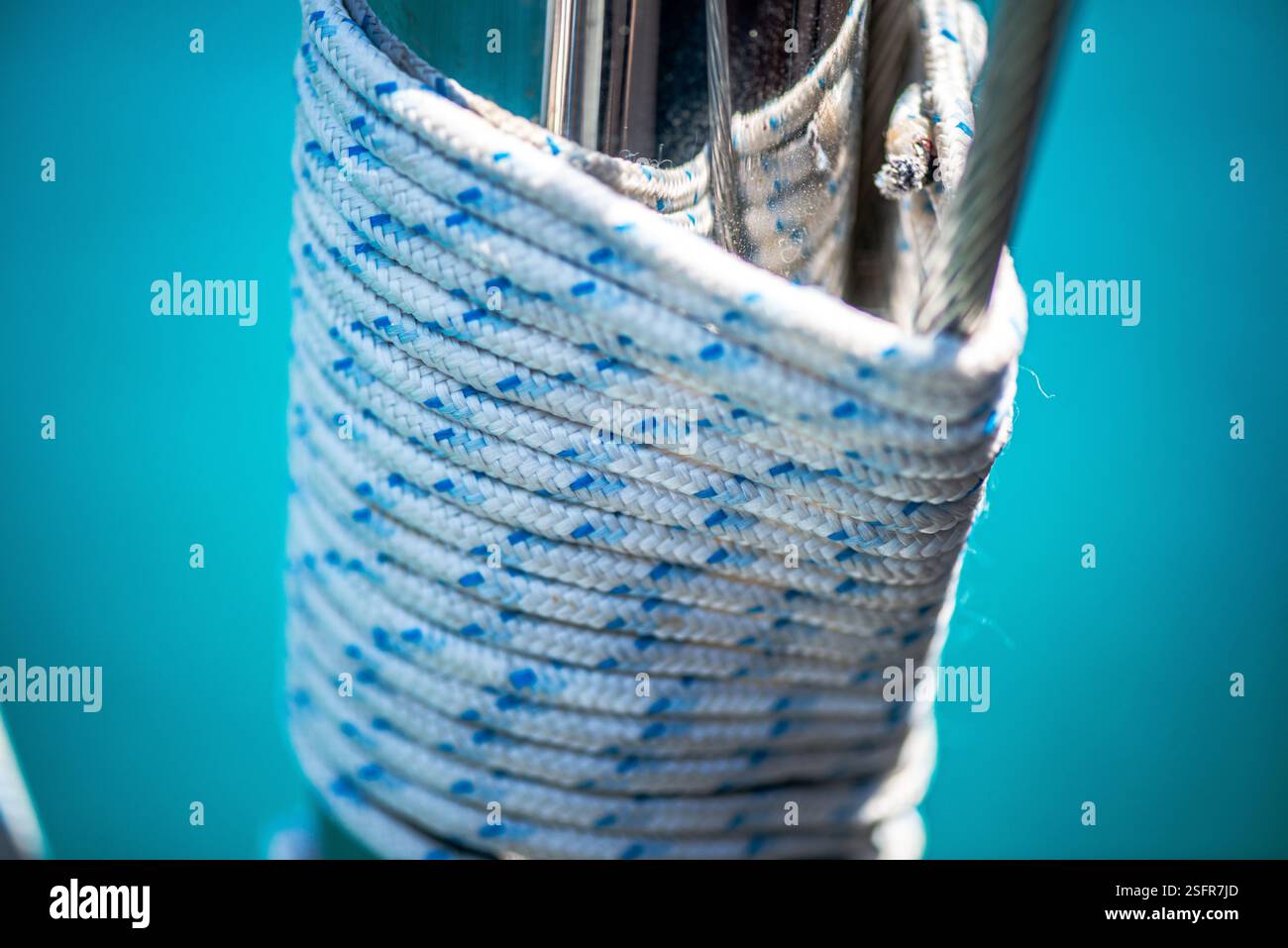 A close-up view of a securely tied rope and knot on a ship mast ...