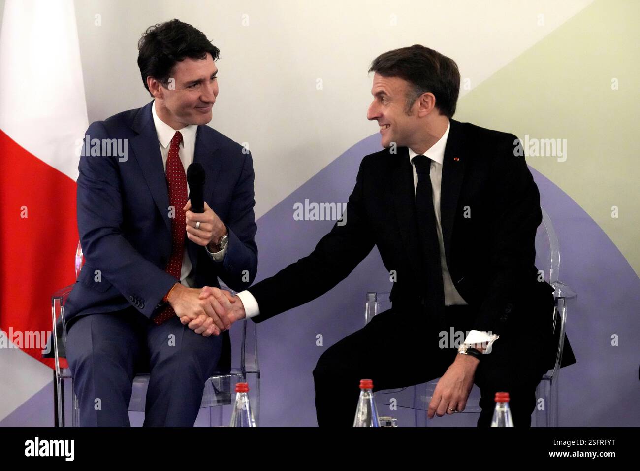 French President Emmanuel Macron, right, shakes hands with Canada's ...