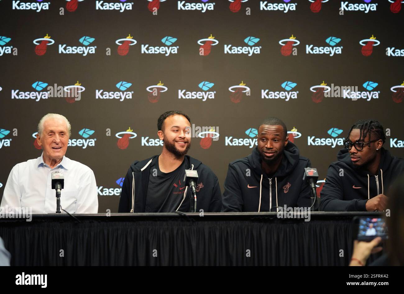 Pat Riley, president of the Miami Heat basketball team, left, sits with newly signed players ...