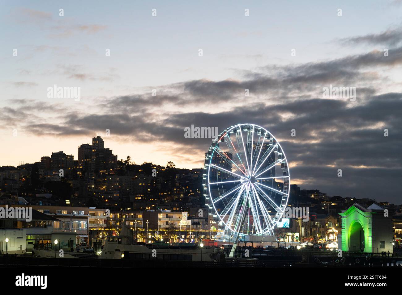 San Francisco's Ferris wheel at Pier 39 at twilight. Illuminated wheel ...