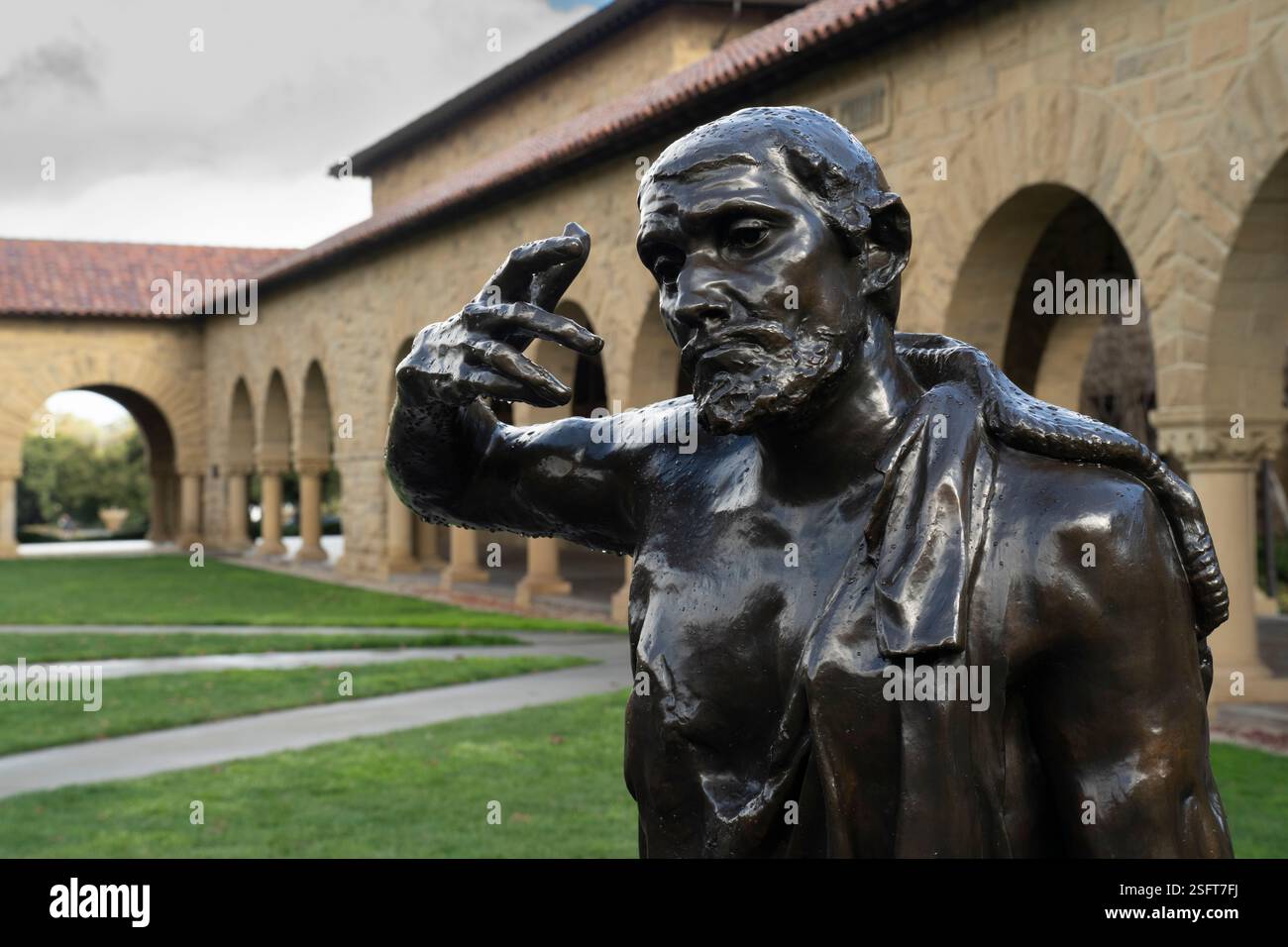 Bronze statue of a figure, likely St. Francis, in the courtyard of the ...