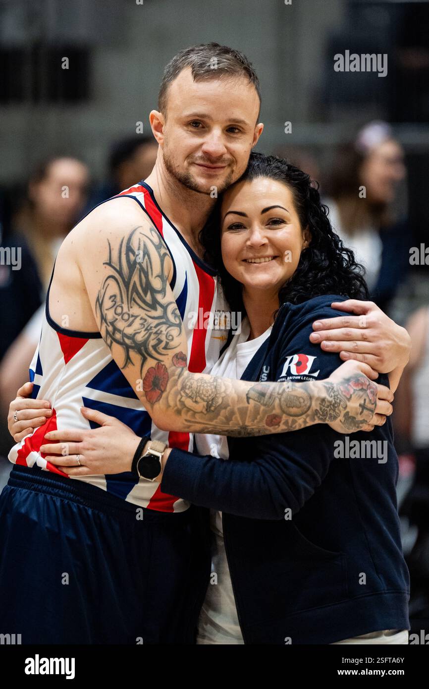 Army veteran James Cairns hugs his partner Hannah Wild after he ...