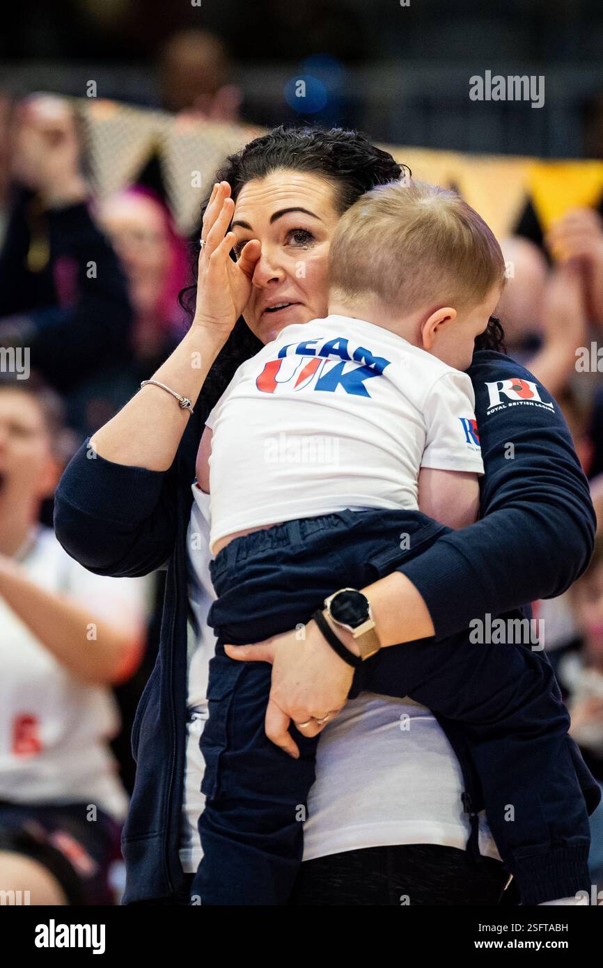 The partner of Army veteran James Cairns, Hannah Wild holding their son ...