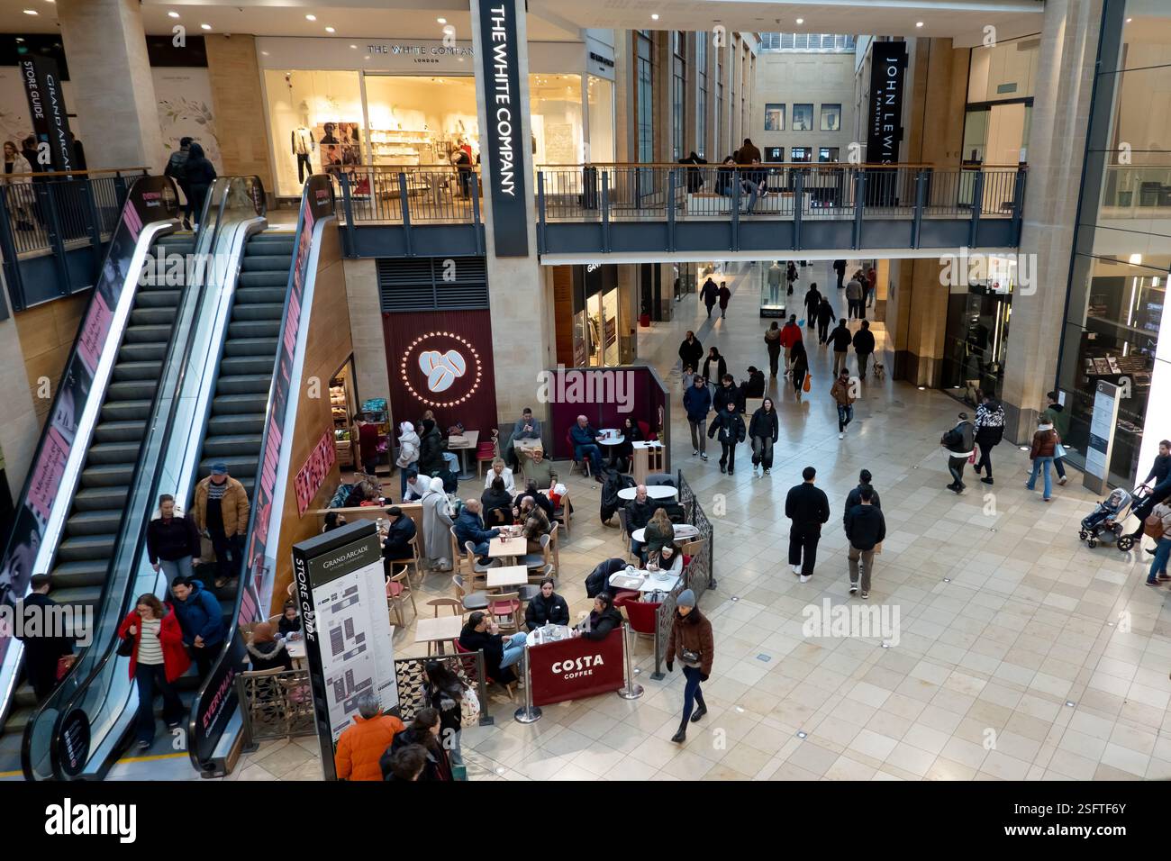 Grand Arcade Cambridge high-angle view with escalators and brand stores ...