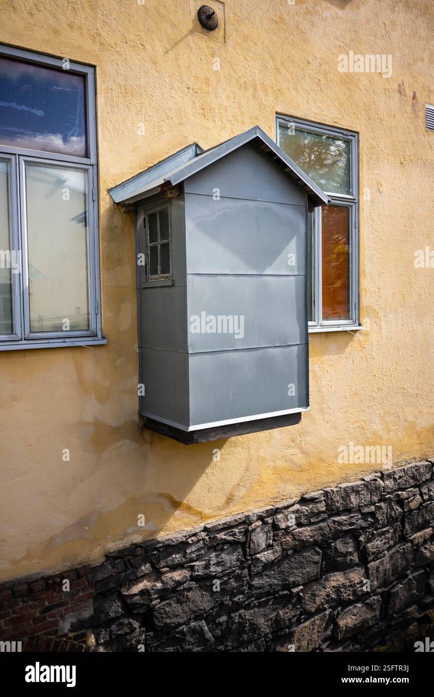 metal-clad bay window on textured yellow wall Stock Photo - Alamy