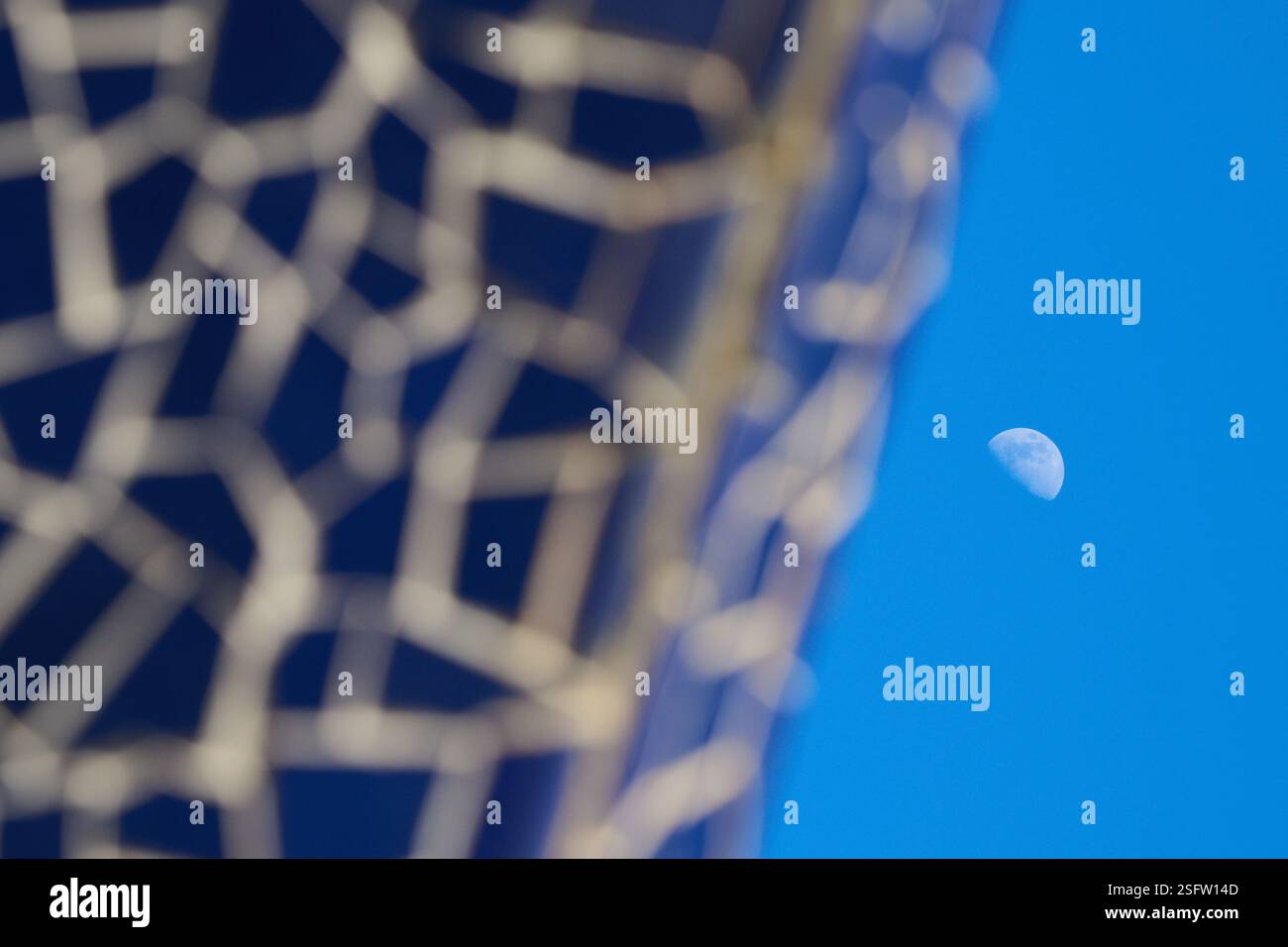 The moon is seen with a detail of a building at the City of Arts and ...