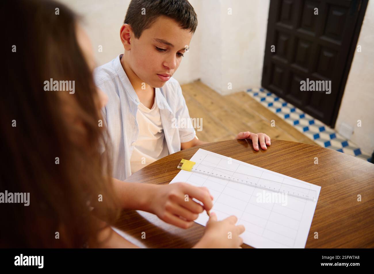 Two children working together on a classroom activity, focusing on ...