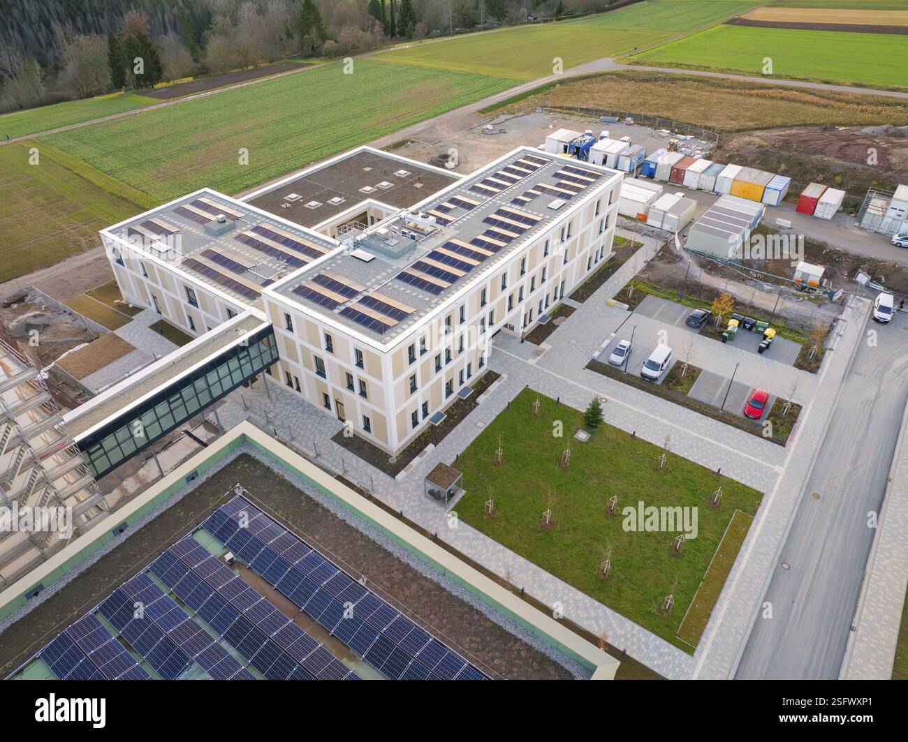 Modern complex with solar panels and green spaces in a rural setting ...