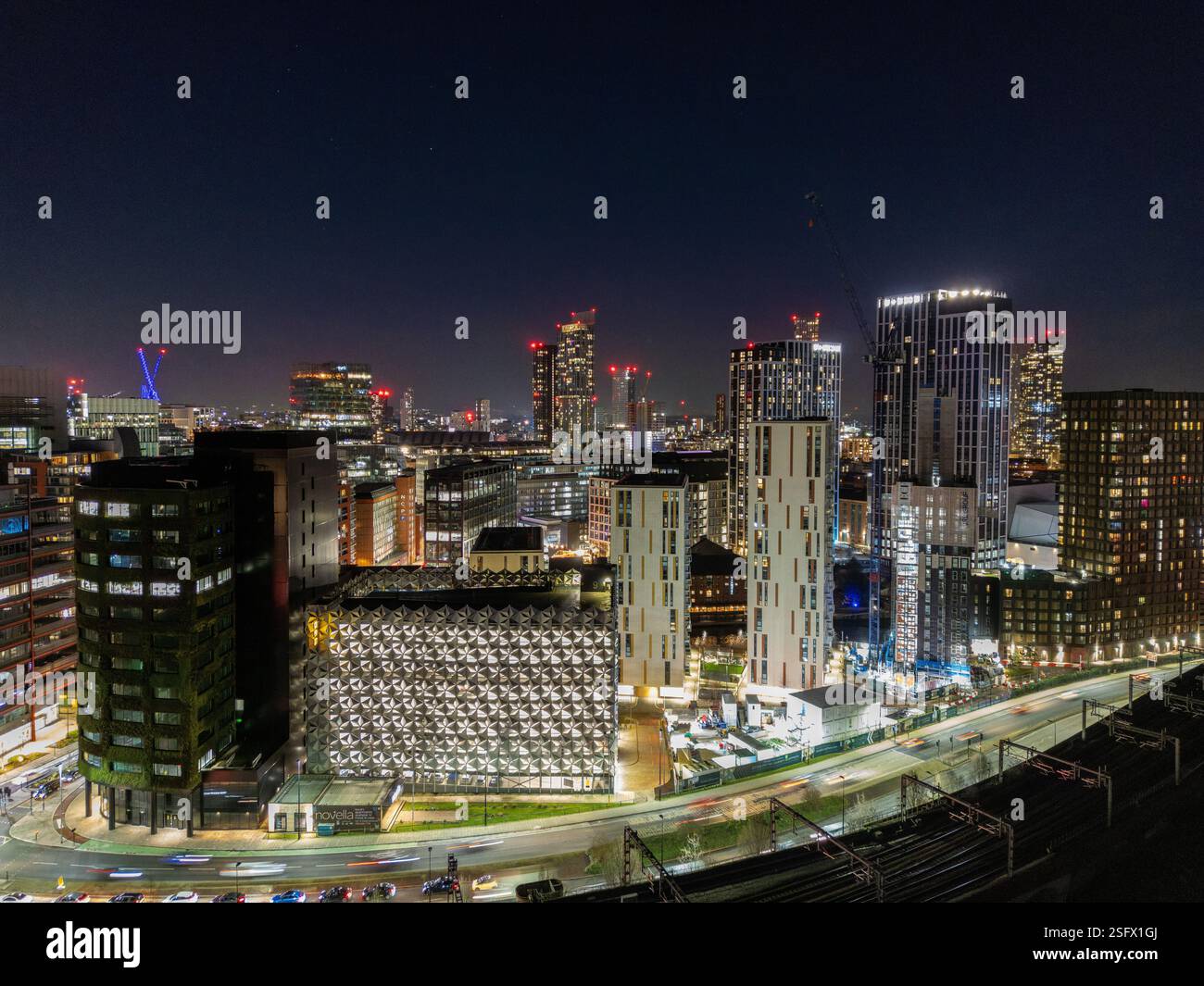 A stunning nighttime view of Manchester's city center showcasing ...