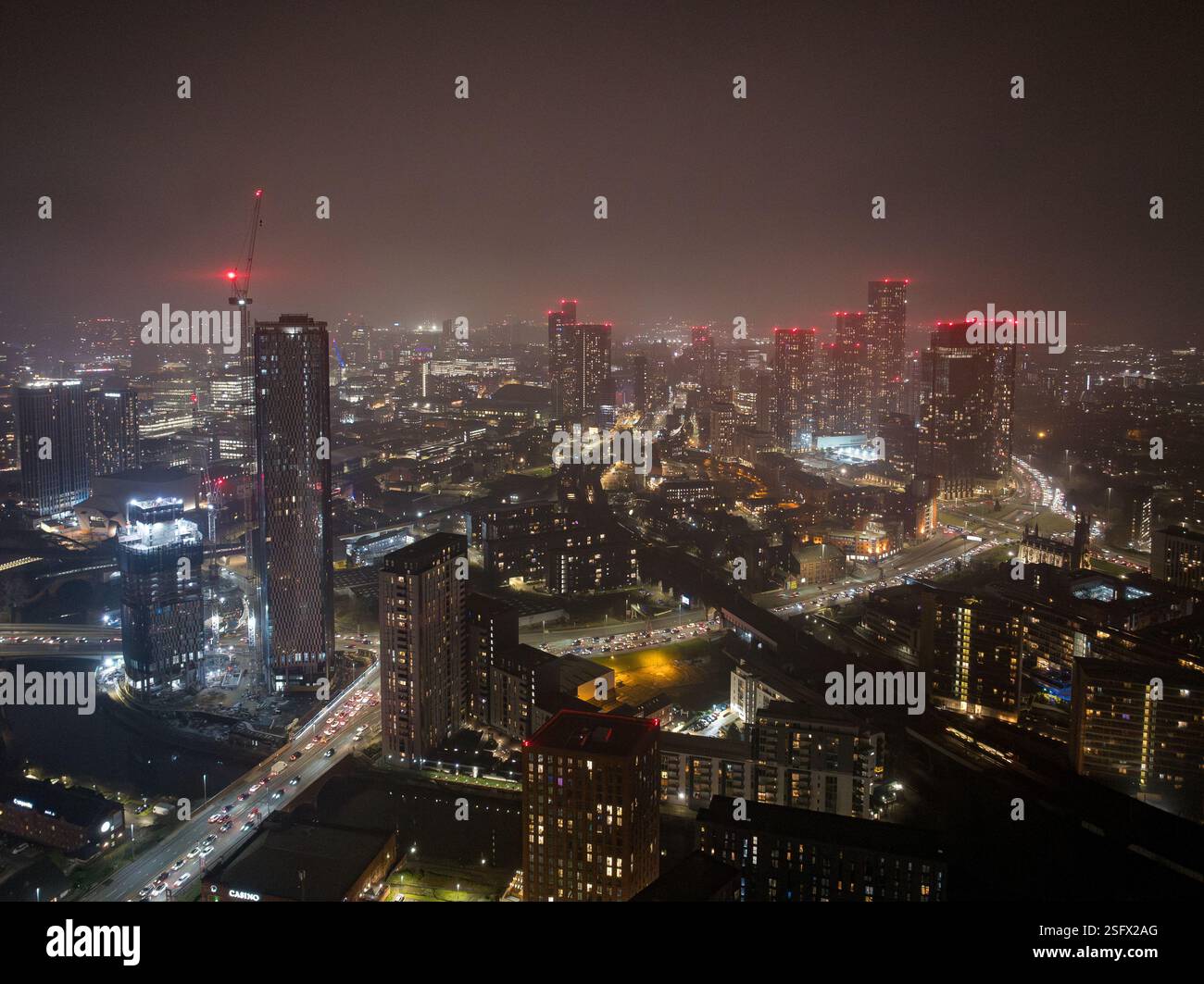 Aerial view of Manchester city center at dusk, showcasing illuminated ...