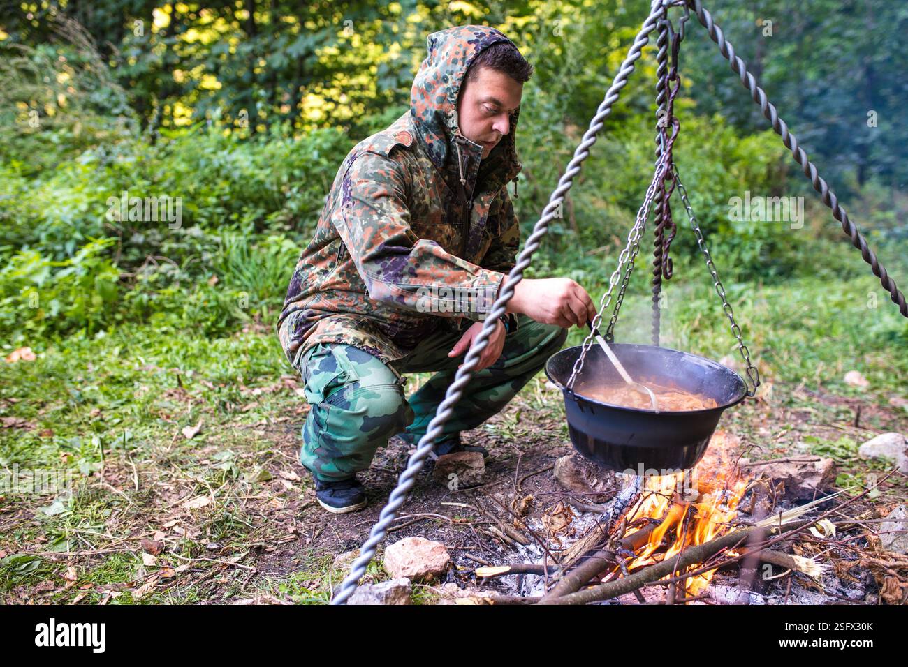 Hunter preparing fire cooking hi-res stock photography and images - Alamy