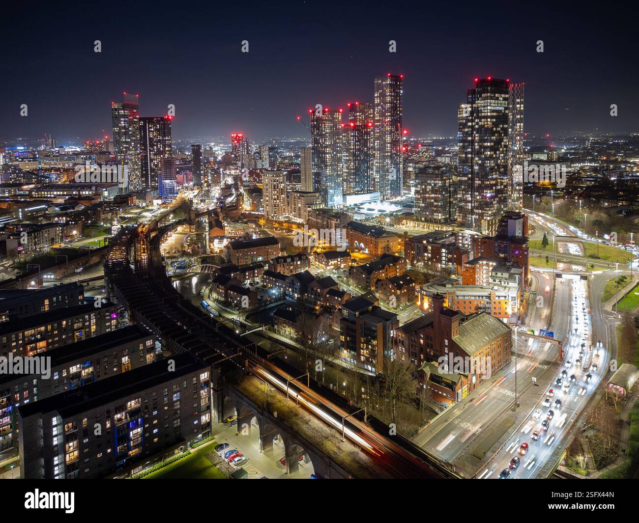 An aerial nighttime view of Manchester city highlighting its ...