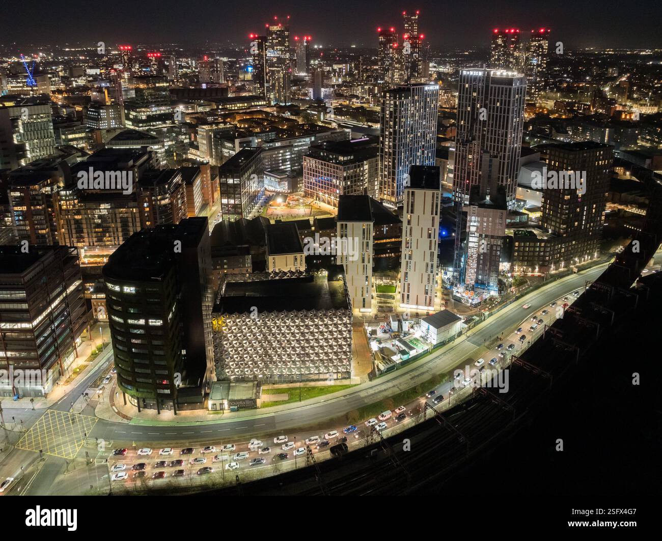 Aerial view of Manchester city center at night showcasing illuminated ...