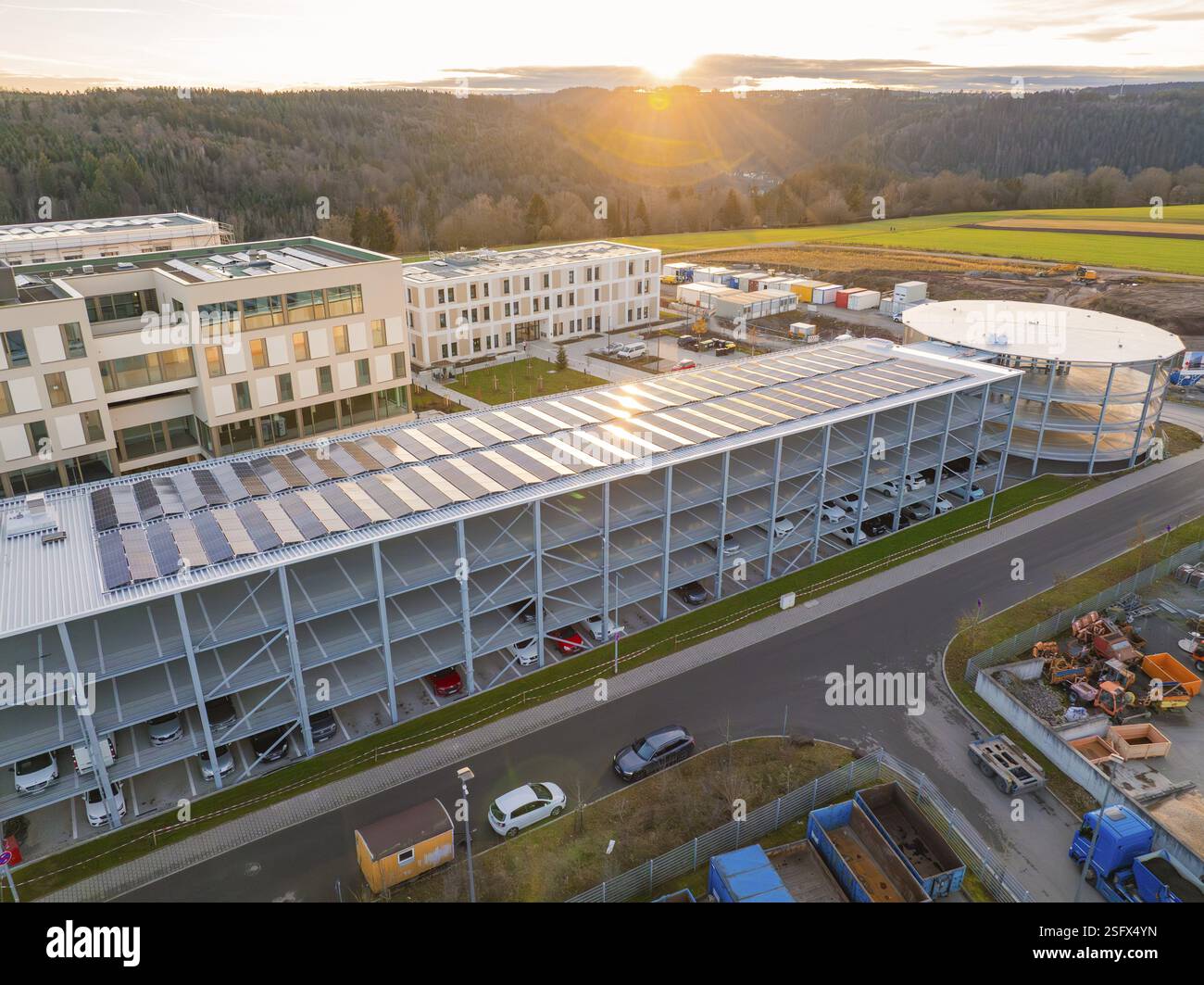 Building complex with solar panels in a rural setting at sunset, new ...