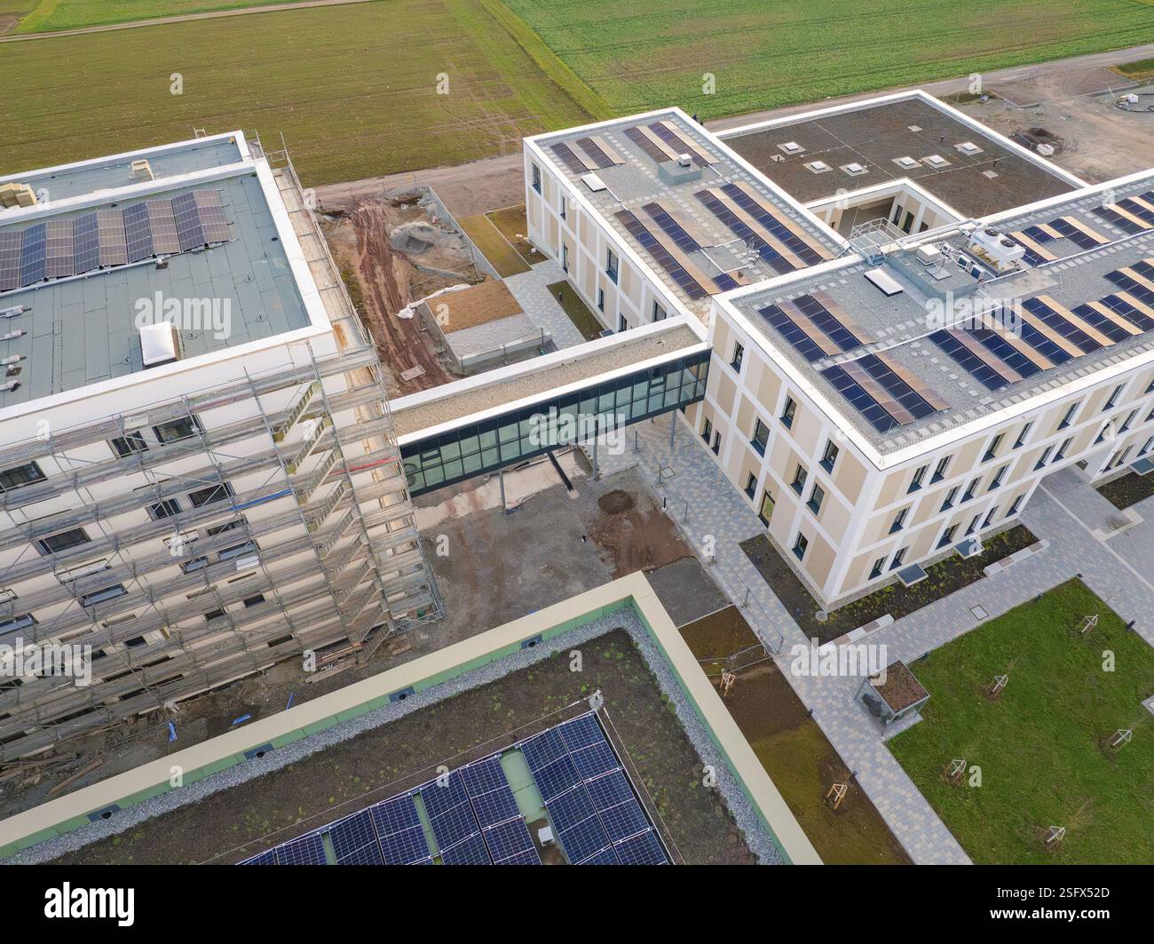Modern buildings on a construction site with solar panels on the roof ...